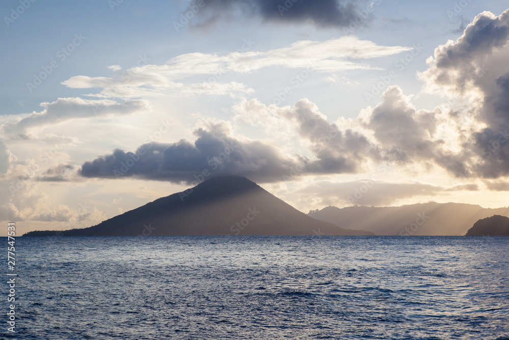 The majestic volcano of Gunung Api rises from the seascape in the Banda ...