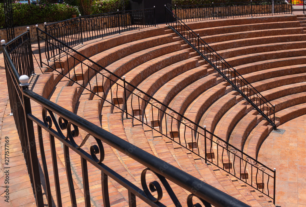 black metal railings against the brick steps of the amphitheater going ...