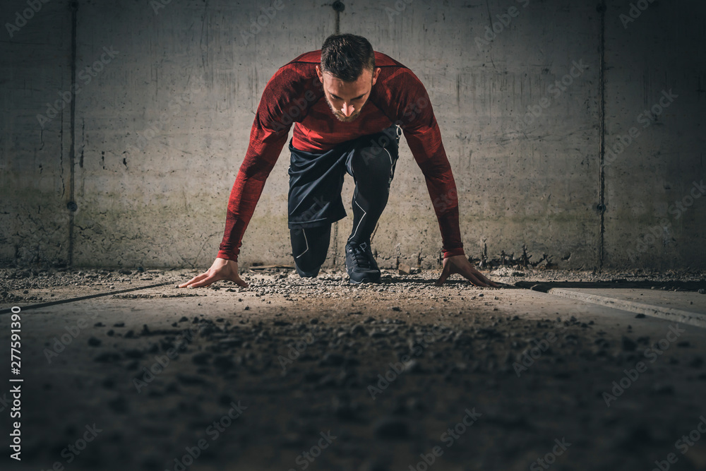 Athlete in a low start pose, starting a race Stock Photo | Adobe Stock