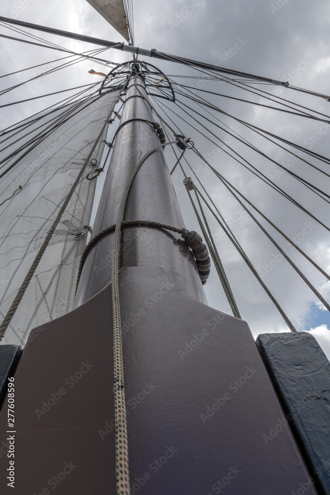 View along the main mast with spreader, rigging and gaffel sail of a ...