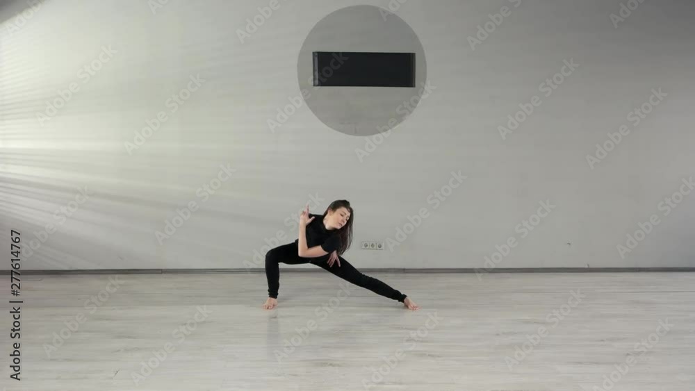 Woman performing modern dance on studio background. Young slim girl ...