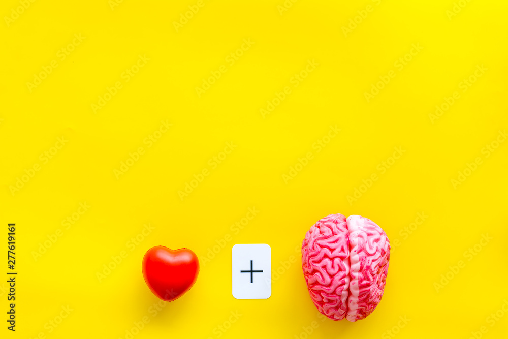 feelings and mind concept with brain plus heart on yellow background ...