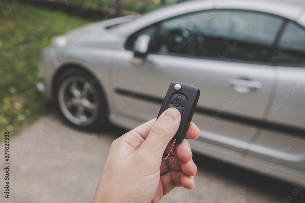 Male car owner switches off the alarm system and unlocks the doors of ...