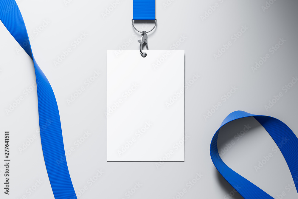 ID card with blue ribbon on the table in white studio. Place for text ...