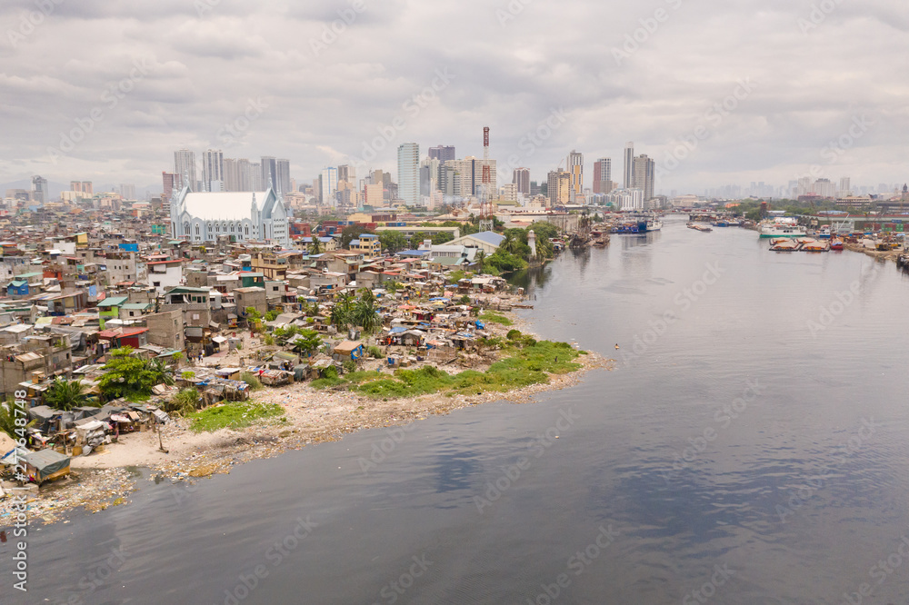The urban landscape of Manila, with slums and skyscrapers. Sea port and ...