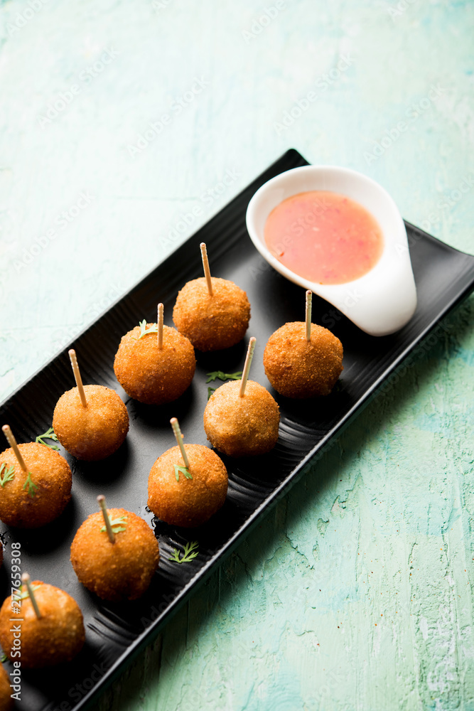 Crispy Veg lollipop recipe made using boiled potato with spices covered ...