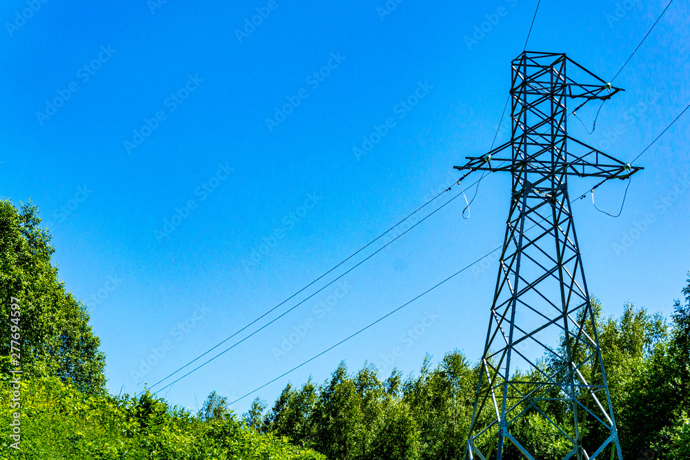 Metal support of high-voltage power line is installed on forest ...