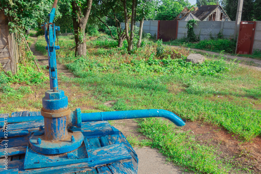 Farm village county water well with hand manual pump. Old utility ...