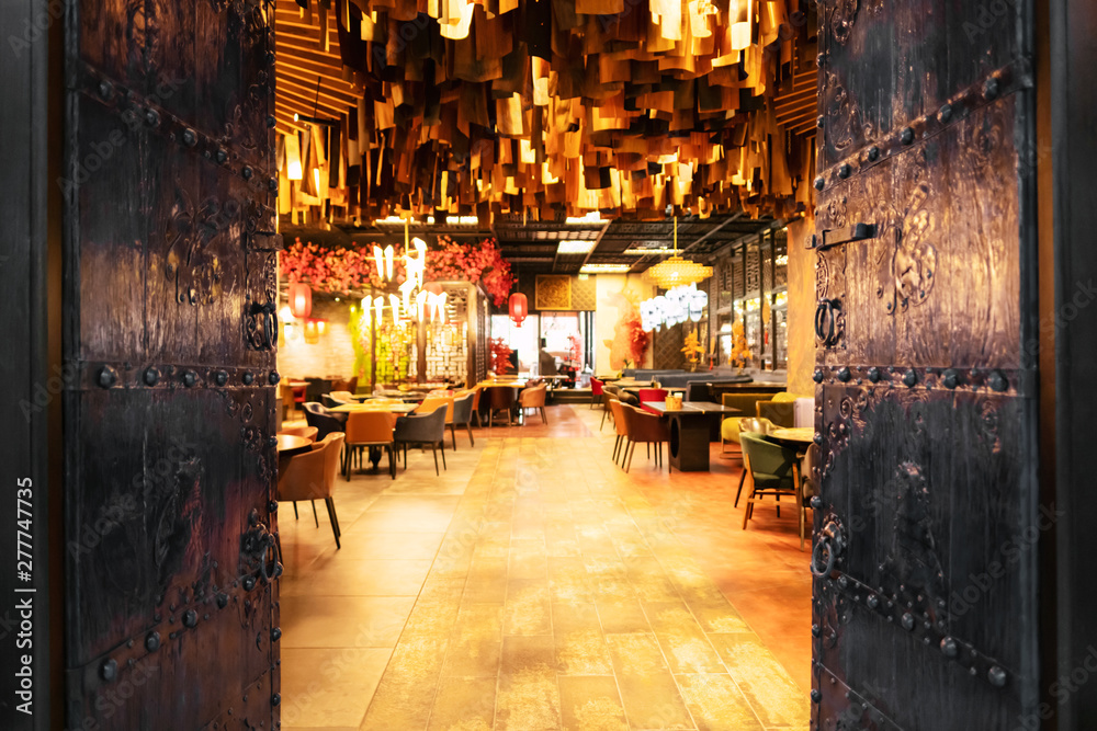 Blurred image of the interior of a large beautiful restaurant with ...