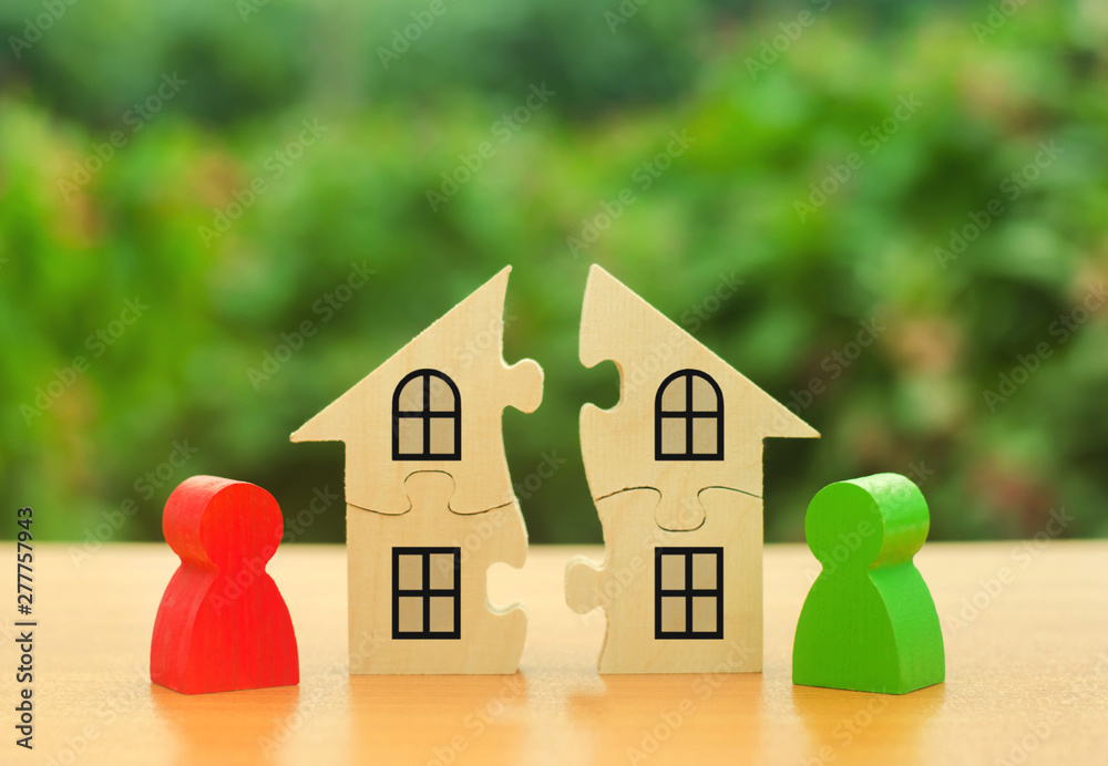 Two human figures divide the house among themselves. Divorce concept ...