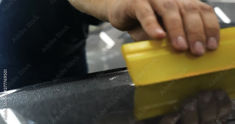 Close up to PPF installation process on a front headlight and hood. PPF ...