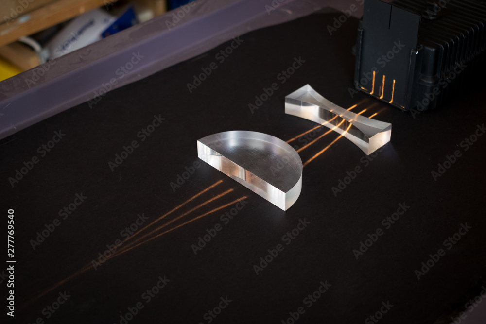 Physics experiment. Light passing through two different kind of lenses ...