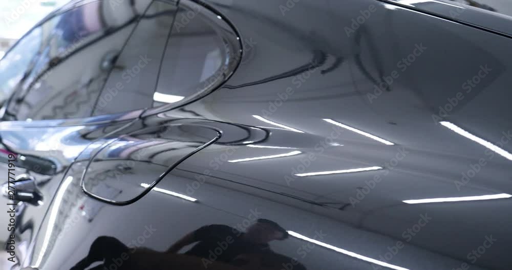 Close up to PPF installation process on a front headlight and hood. PPF ...