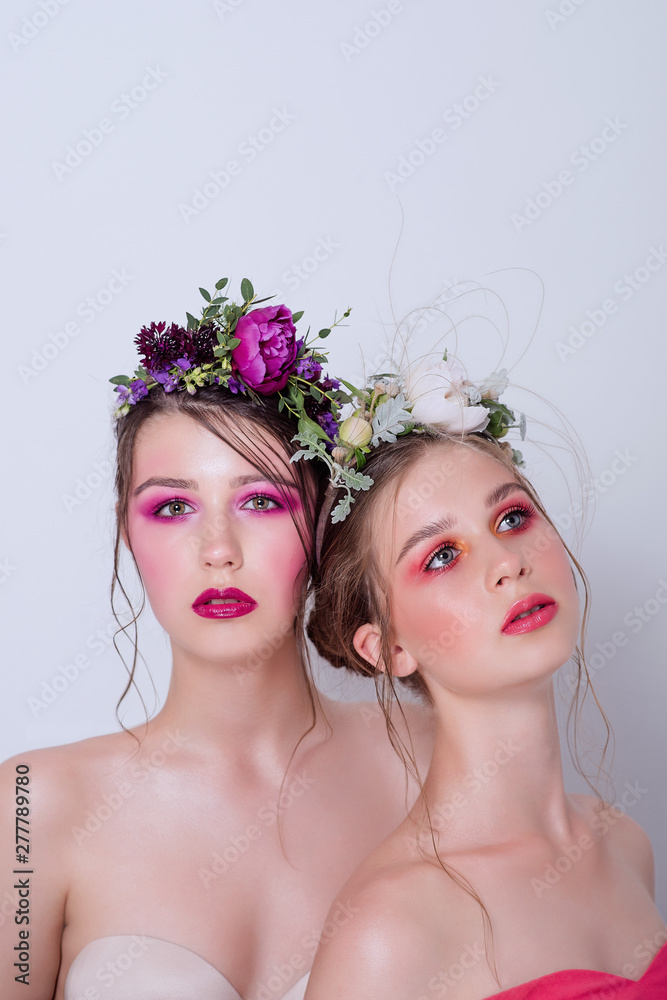 Two fashion beauty models sister girls with professional bright make-up ...