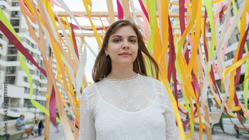 Beautiful young smiling woman on the background of colored wackies or ...