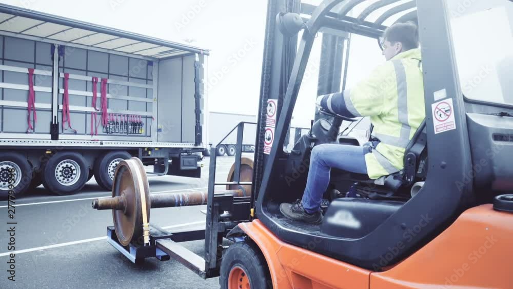 Tracking forklift while loading on a truck Stock Video | Adobe Stock