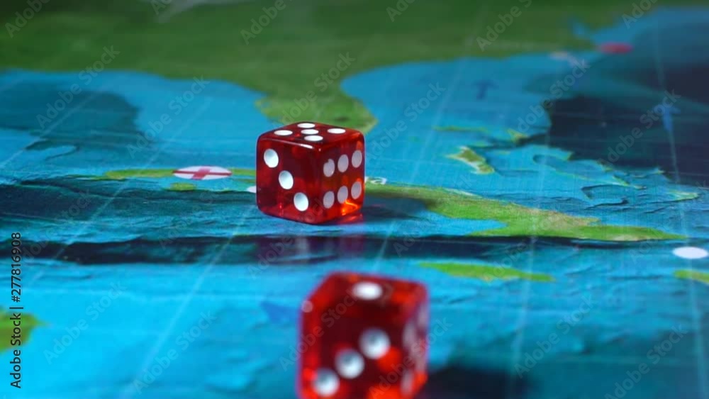 Hand throwing red dice on the world map of the playing field handmade ...