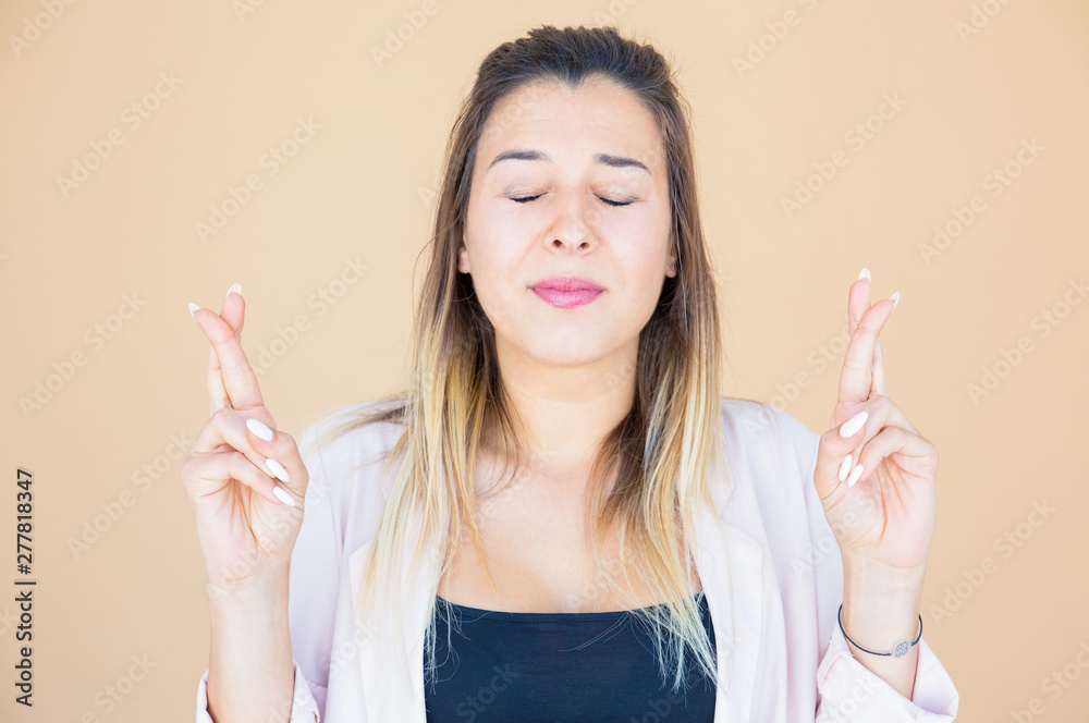 Excited worried lady making wish. Concerned young woman with closed ...