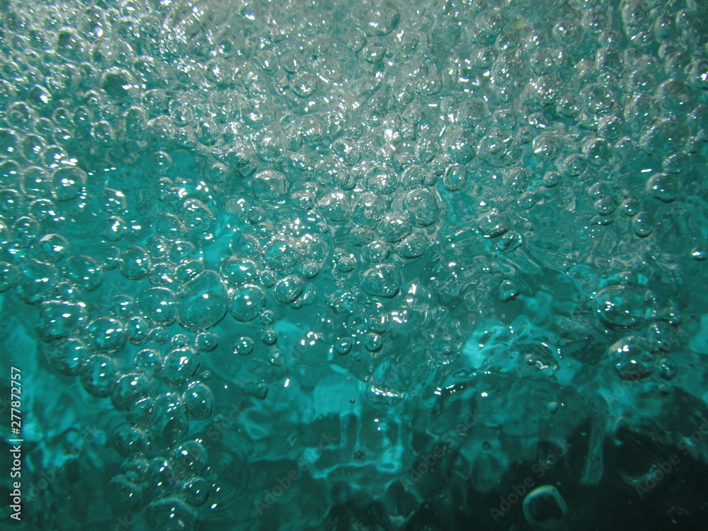 Small air bubbles in the water. Underwater background. Aquamarine ...