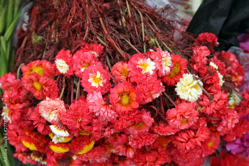 Flowers and garlands for sale at the flower market in the shadow of the ...