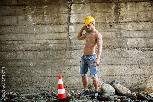 Sexy, muscular construction worker shirtless, working outdoor, wearing ...