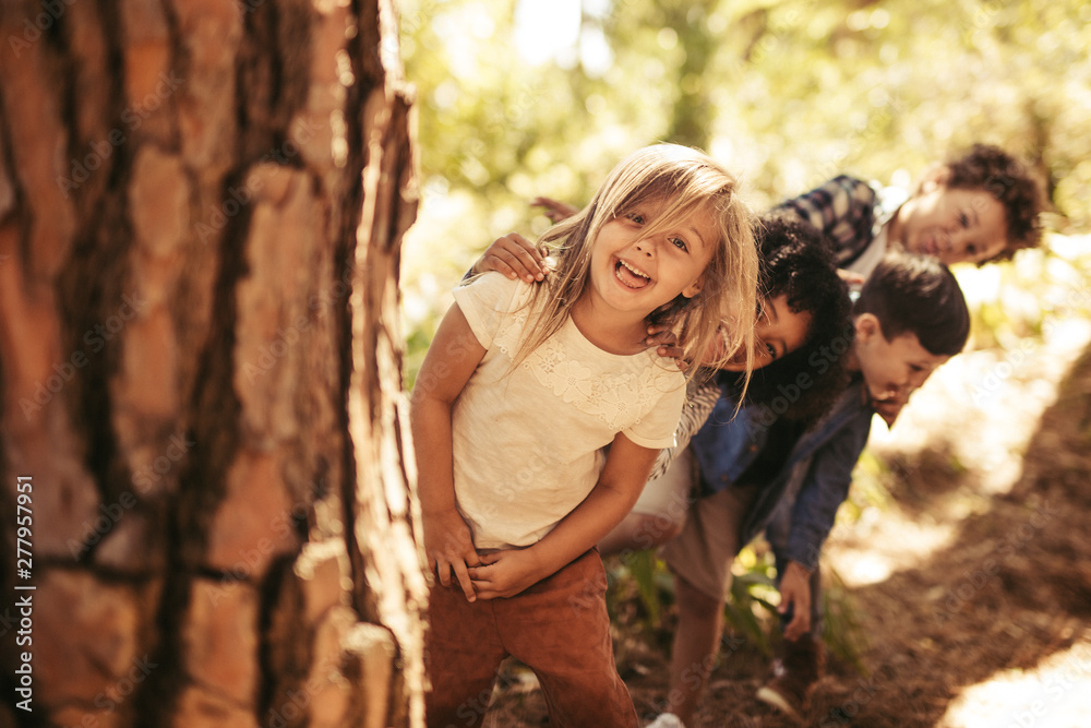 Kids playing hide and seek in a park Stock Photo | Adobe Stock