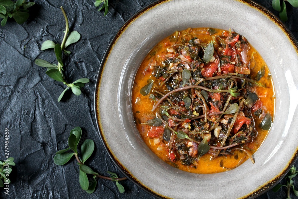 dish of purslane. potulak-edible useful weed. stalks of purslane stewed ...