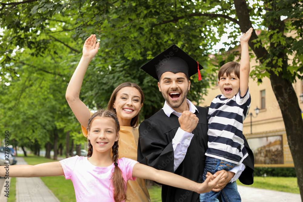Happy man with his family on graduation day Stock Photo | Adobe Stock