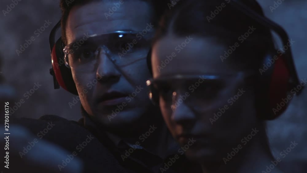 Portrait Man Teaches A Woman How To Shoot A Gun Indoors Pistol Speed Firing Girl Police Practice
