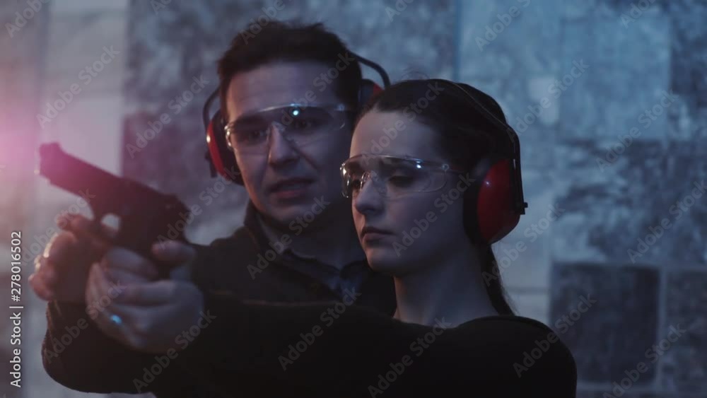 Slow Motion Man Teaches A Woman How To Shoot A Gun Indoors Pistol Speed Firing Girl Police