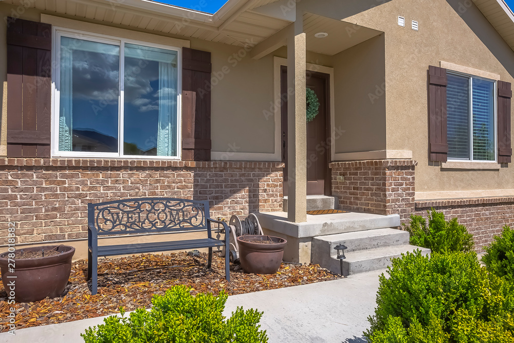 Pathway and steps leading to the door of a home with concrete and brick ...