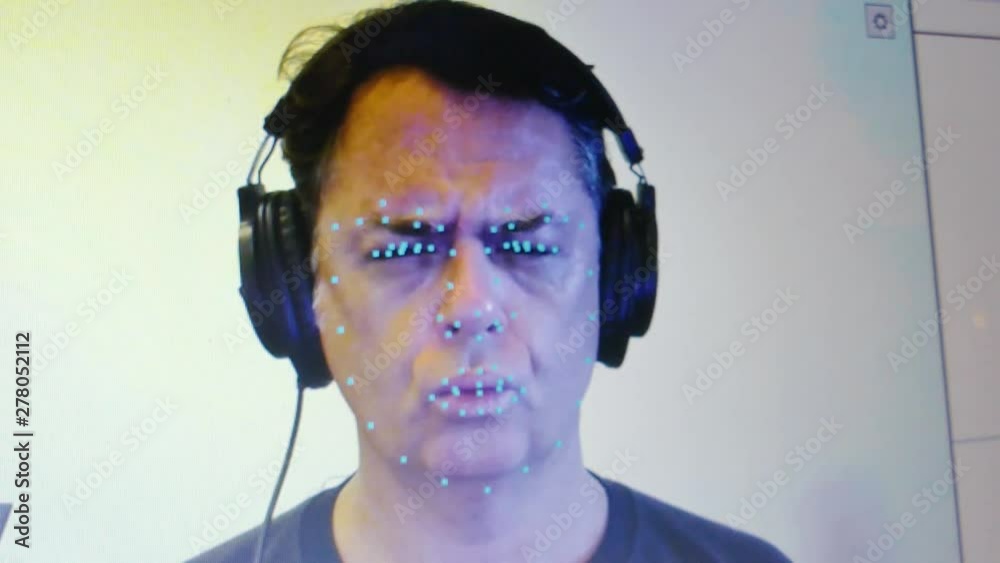 Close up of a man using motion tracking facial recognition system; such ...