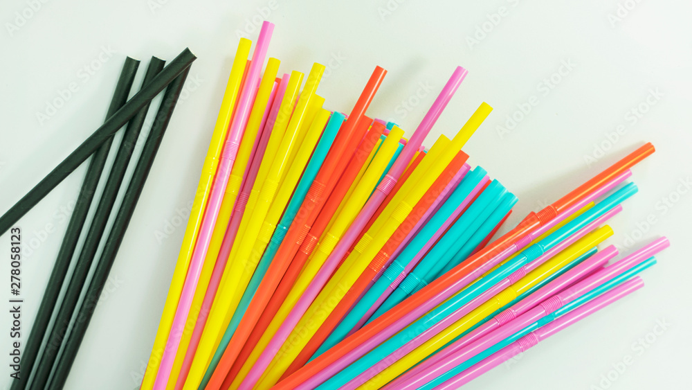 Multi colored plastic drinking straws and a few black paper drinking ...