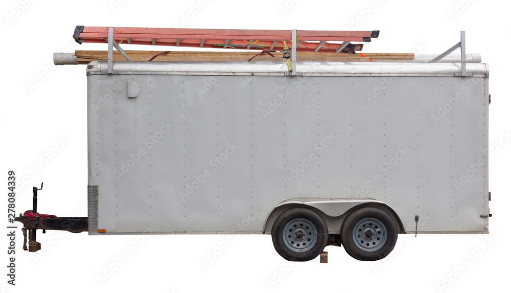 Side view of older white utility work trailer parked in residential ...