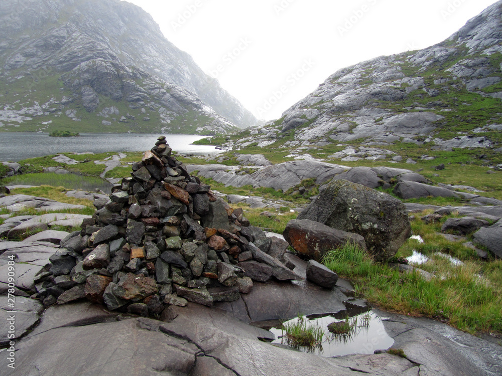 Heap of stones pointing the right way on a path from the island of Skye ...
