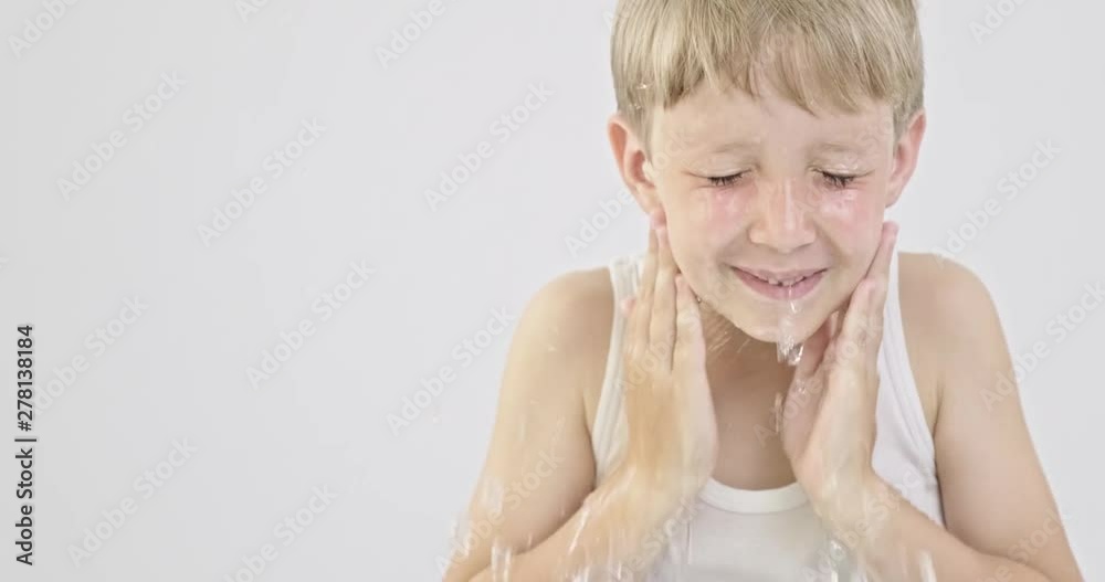 Little boy washing her face with water. Cute little child washes face ...