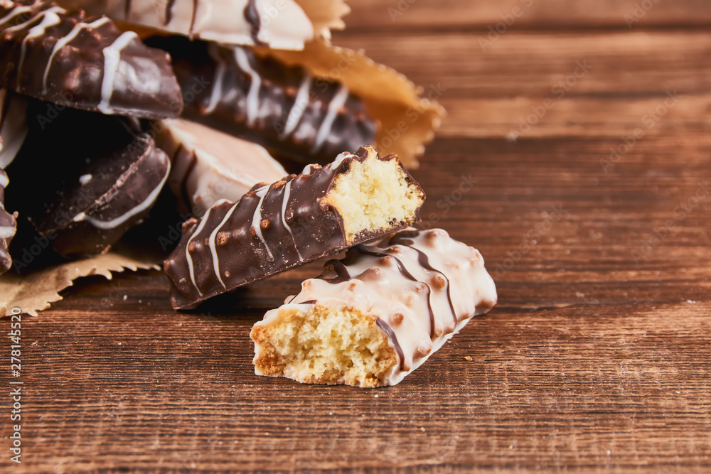 One broken cookie and long sticks shortbread cookies in dark and white ...