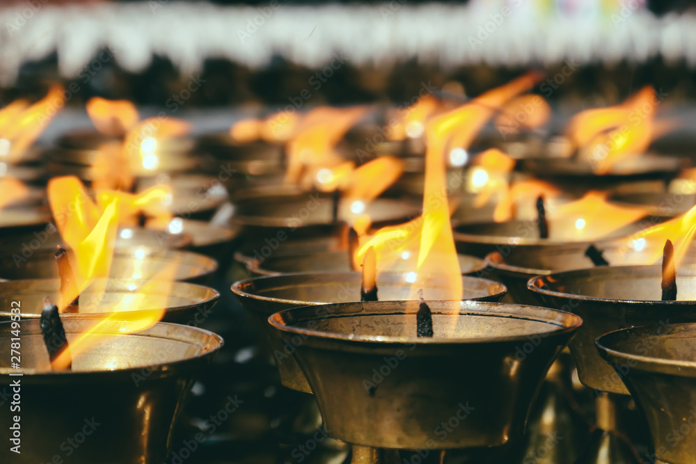 Burning rays of oil candles as part of Buddhist ritual observances at ...