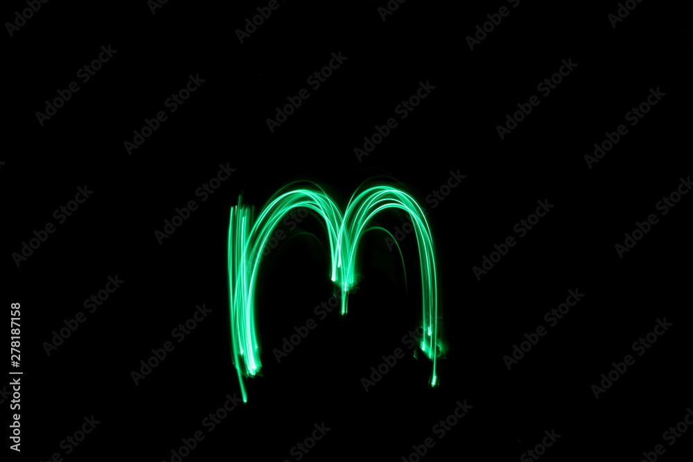 Long exposure photograph, light painting photography. Letter m of an ...