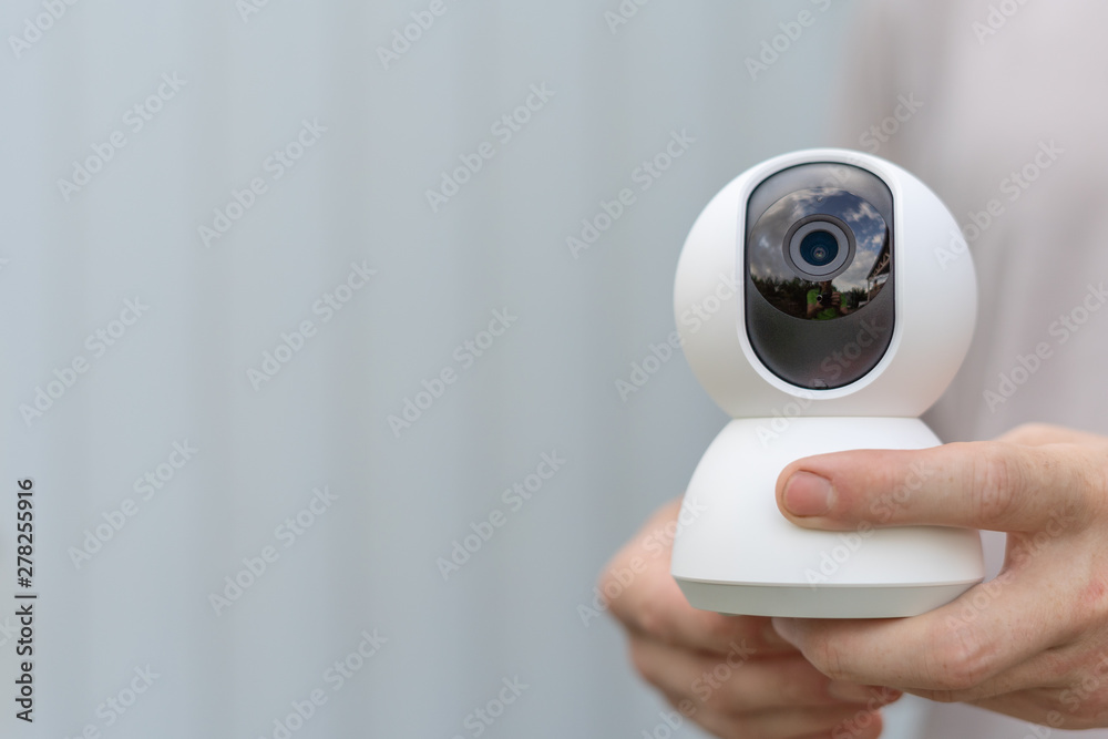 Man hold CCTV smart camera. 360 degree rotating security internet of ...