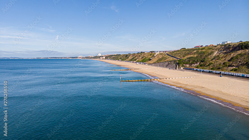 An aerial view of a majestic sandy beach with crystal blue water sea ...