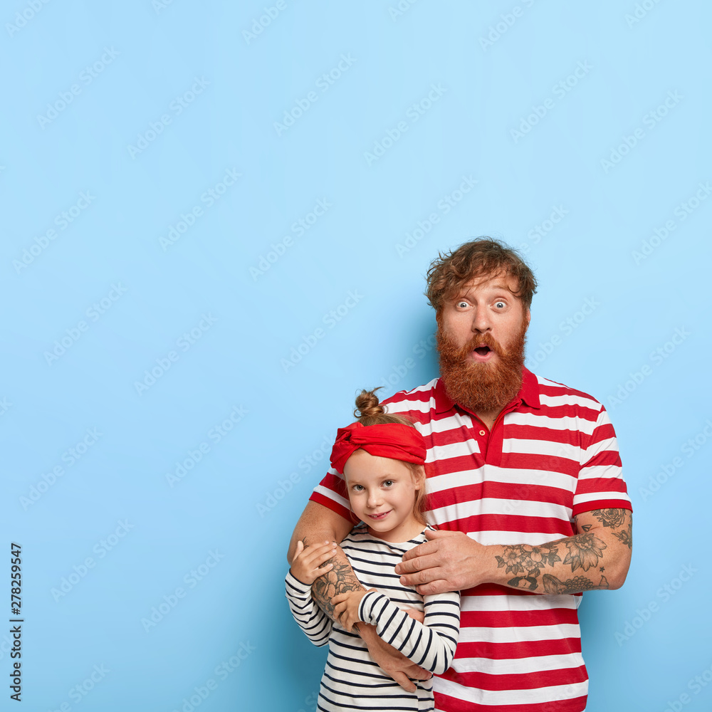 Shocked bearded redhead father in striped t shirt and his preschool ...