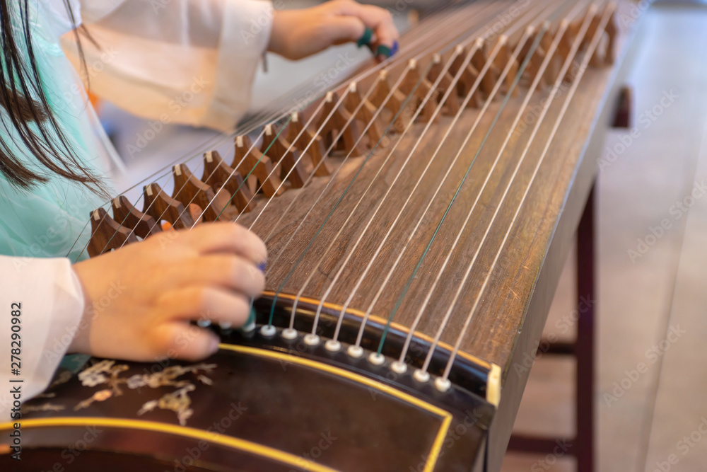 Playing the Chinese zither Stock Photo | Adobe Stock