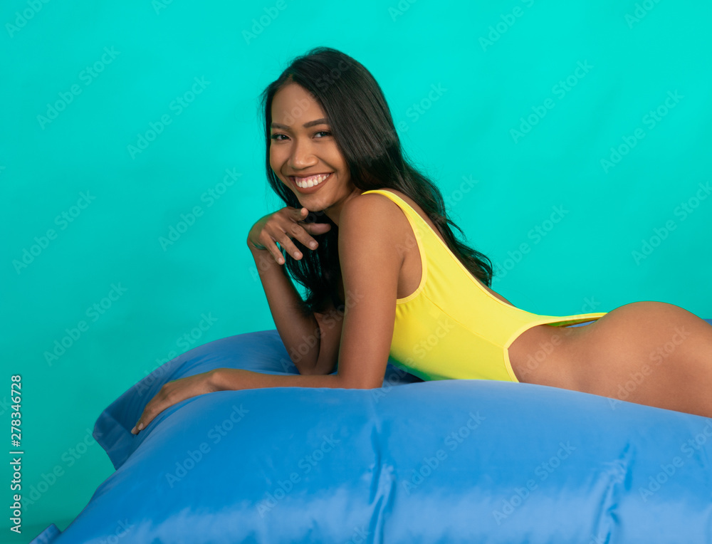 Bright Summer Portrait Of Beautiful Smiling Woman In Yellow Swimsuit