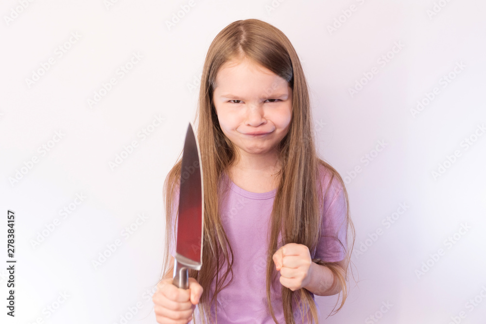 Little girl holding a big knife, with an angry expression and clenched ...
