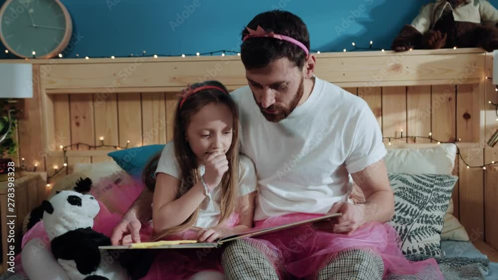 Pretty magic fairies dad and daughter reading exciting book together ...