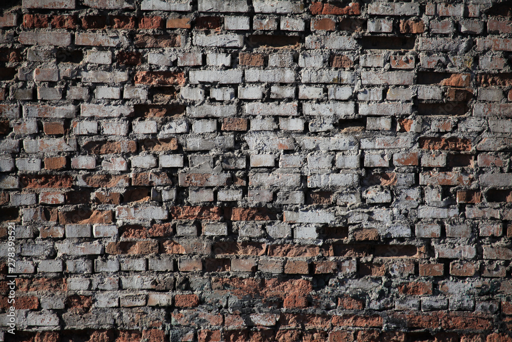 Old brick wall texture. The wall, made of old red bricks, darkened by old age. Ancient vintage ...