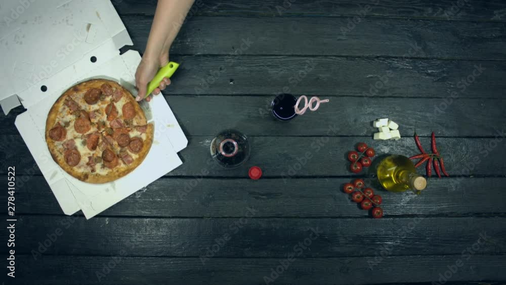 Soda and super meat pizza on ecological black background. Girl takes ...