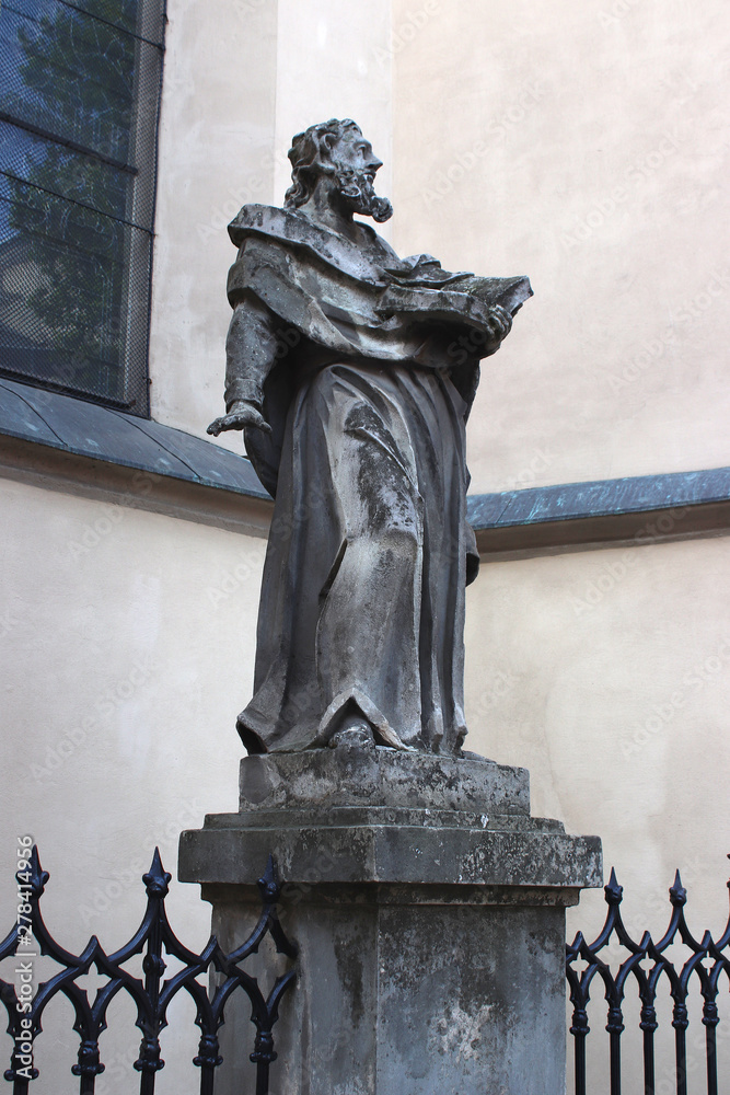 Ancient stone statue of a catholic saint with a book. Element of the ...