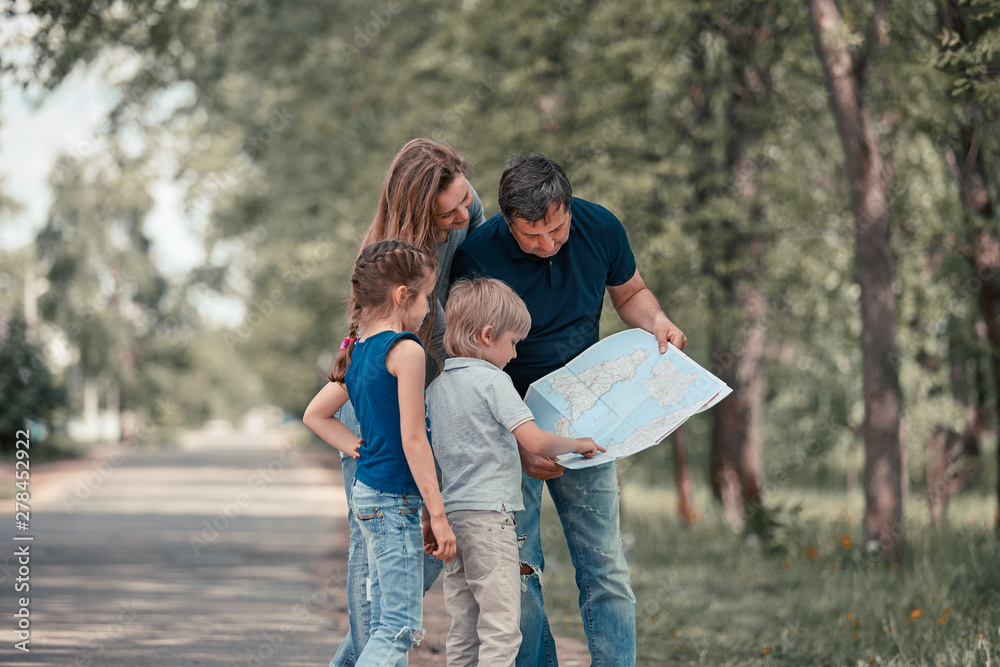 family with their children discussing the route on the map Stock Photo ...